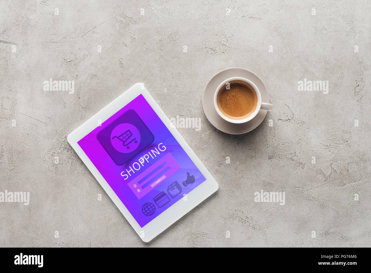 top view of cup of coffee and tablet with shopping app on screen on ...