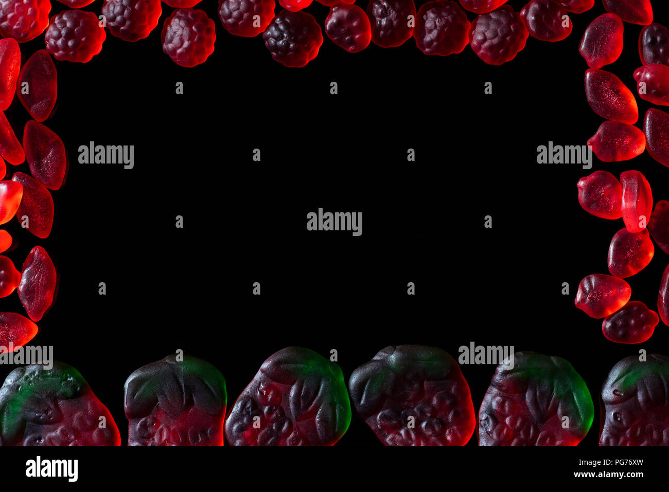 top view of frame of jelly candies in shape of raspberries and ...