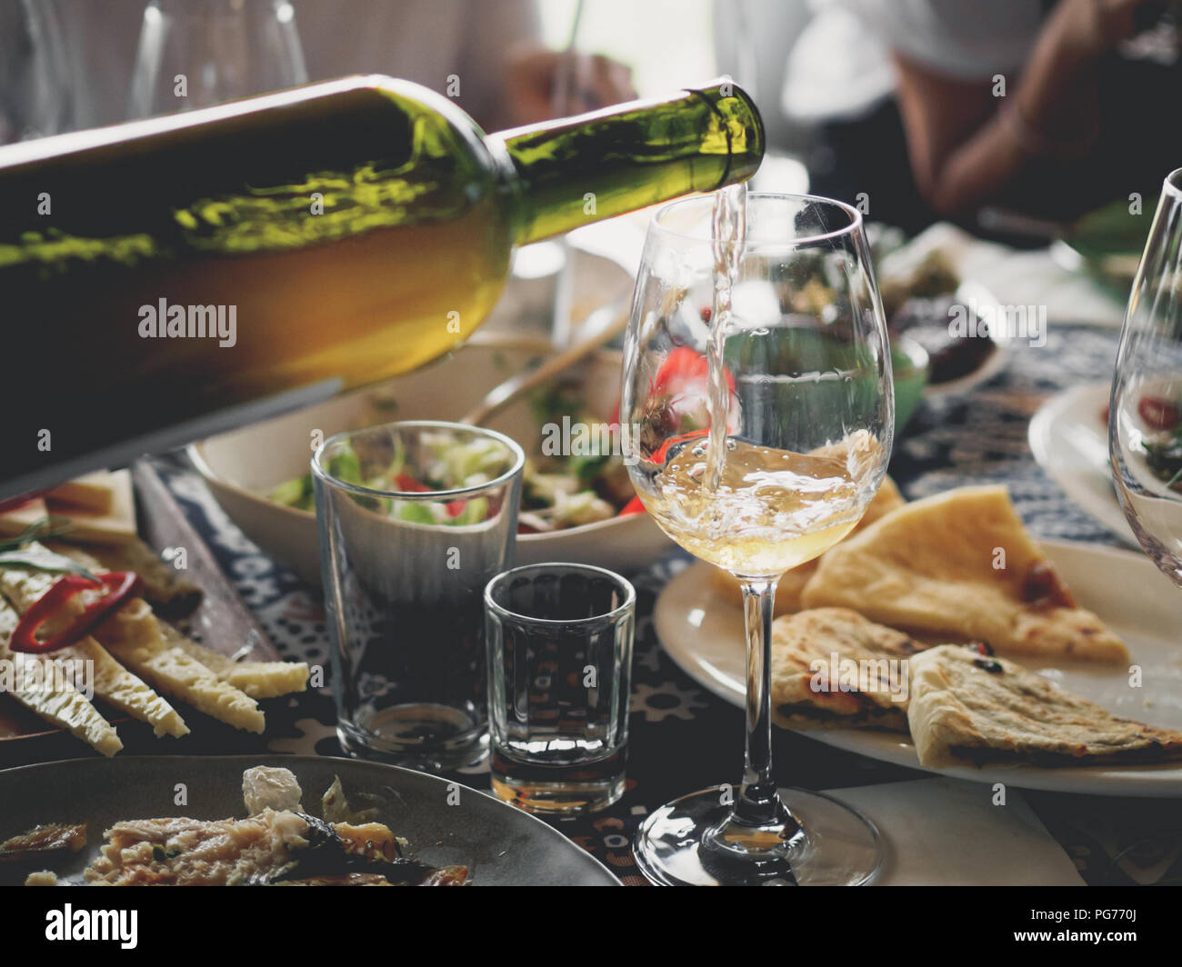 wine pouring from bottle into glass at home in georgia Stock Photo - Alamy