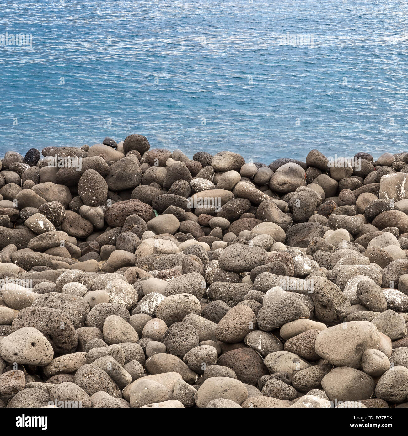 Volcanic rock beach and sea- ideal for backgrounds Stock Photo - Alamy