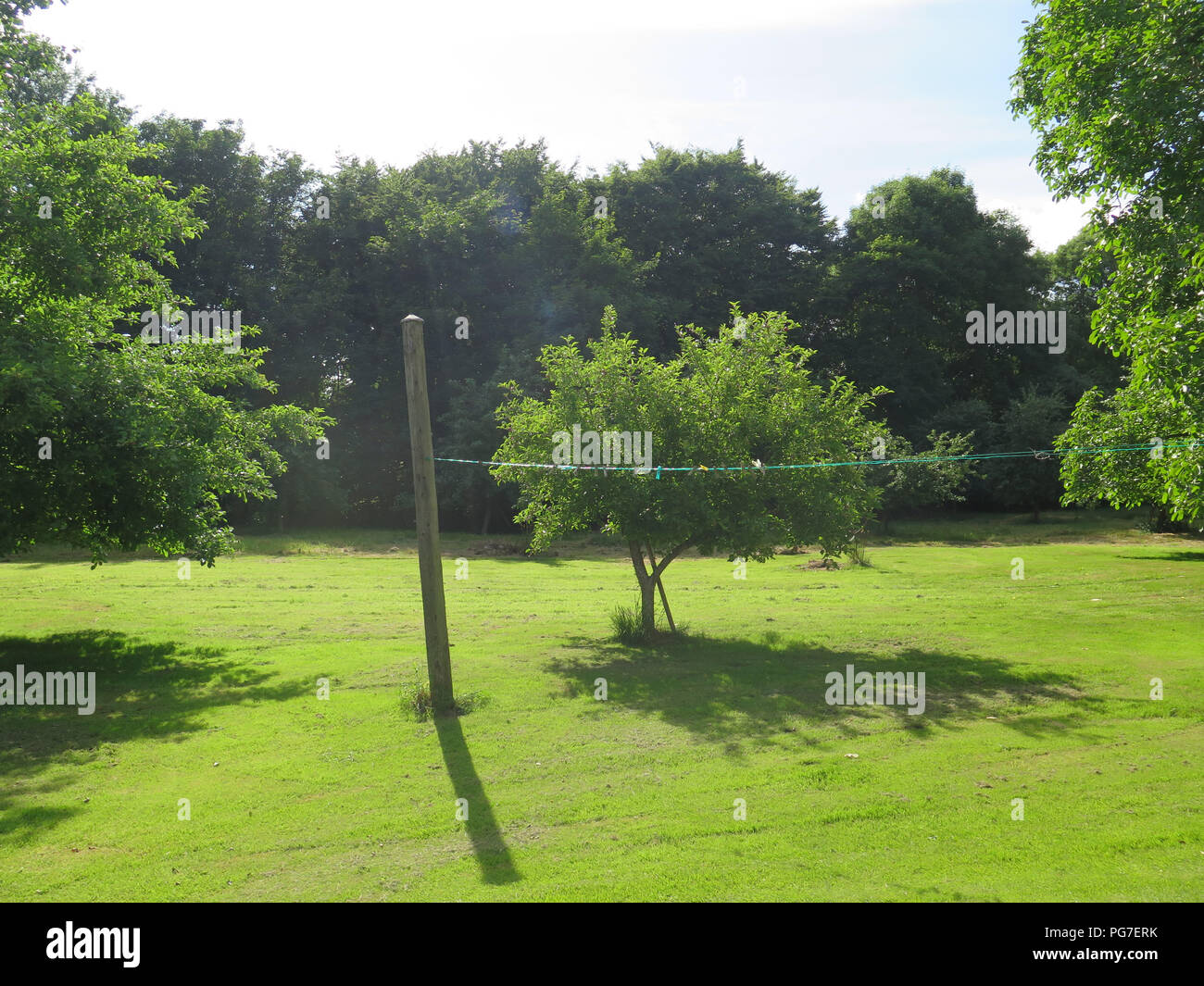 Wooden post and cloth line on farmhouse lawn in Southern Denmark Stock ...