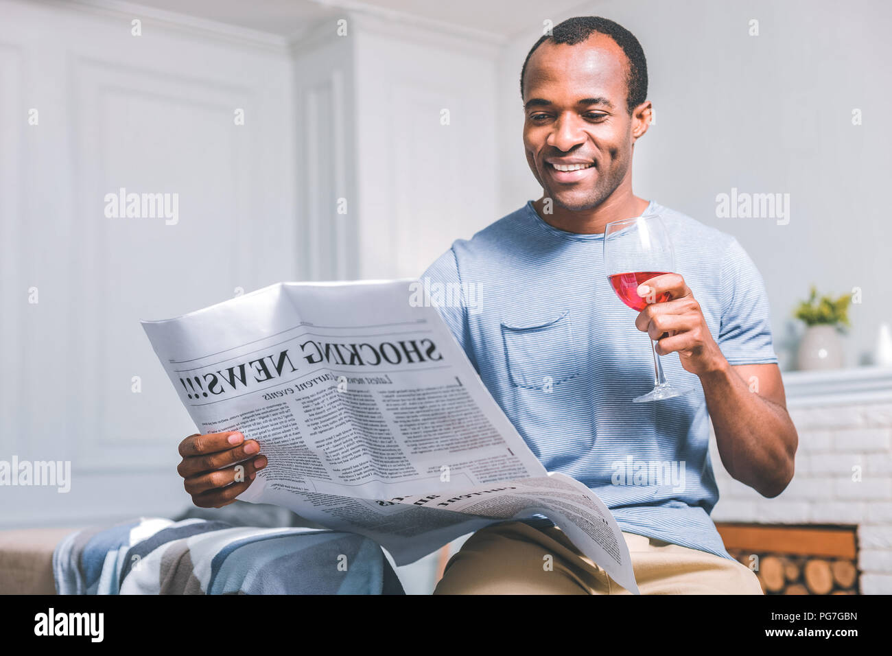 Cheerful man holding a newspaper Stock Photo - Alamy