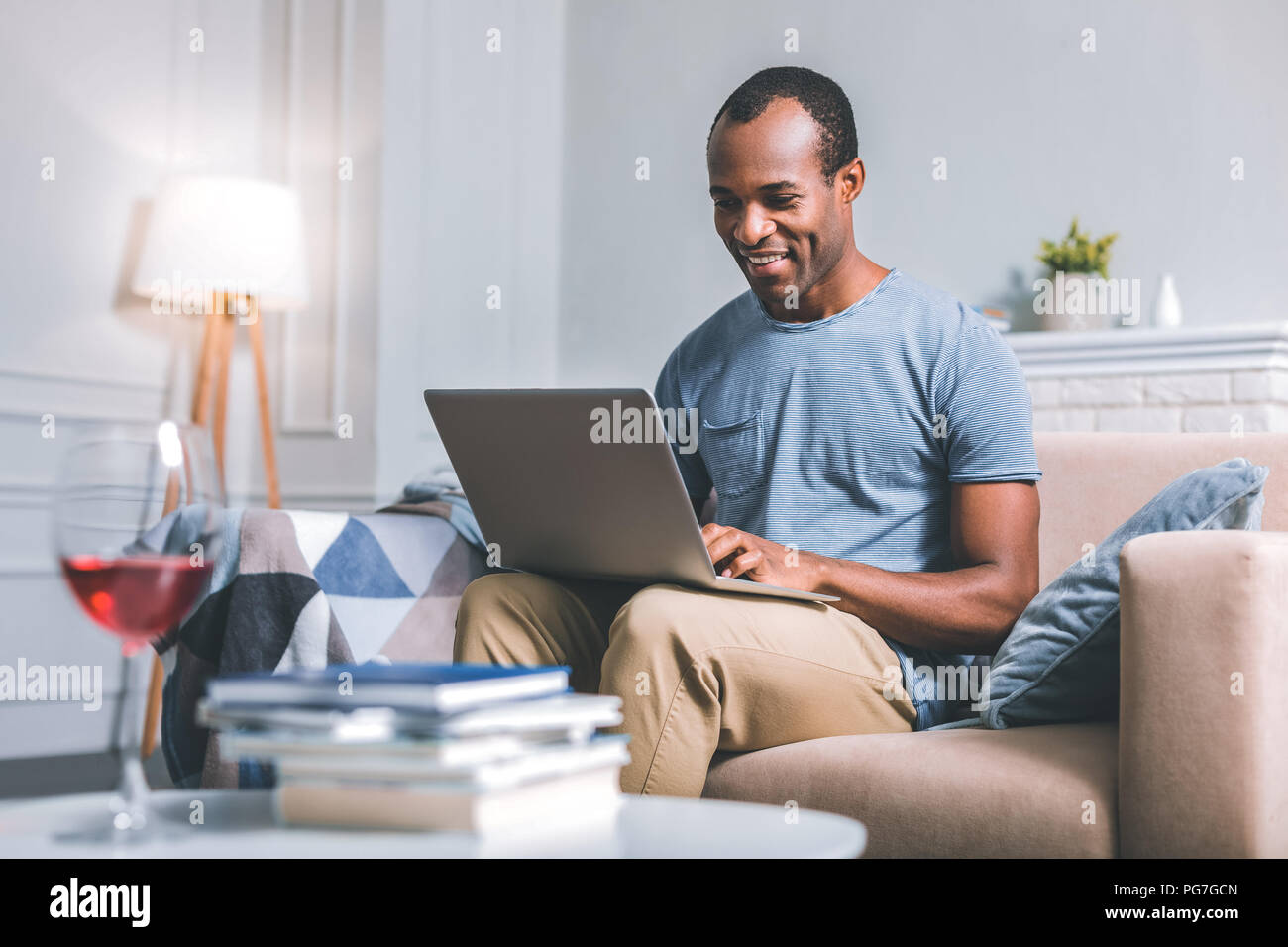 Smiling man working remotely Stock Photo - Alamy