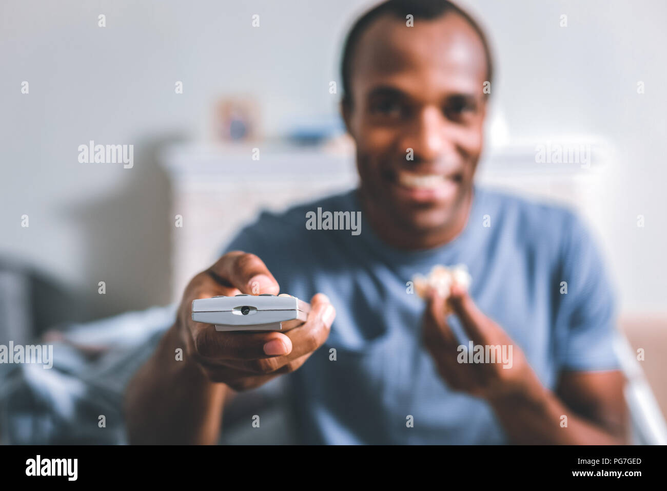 Young man watching TV Stock Photo - Alamy