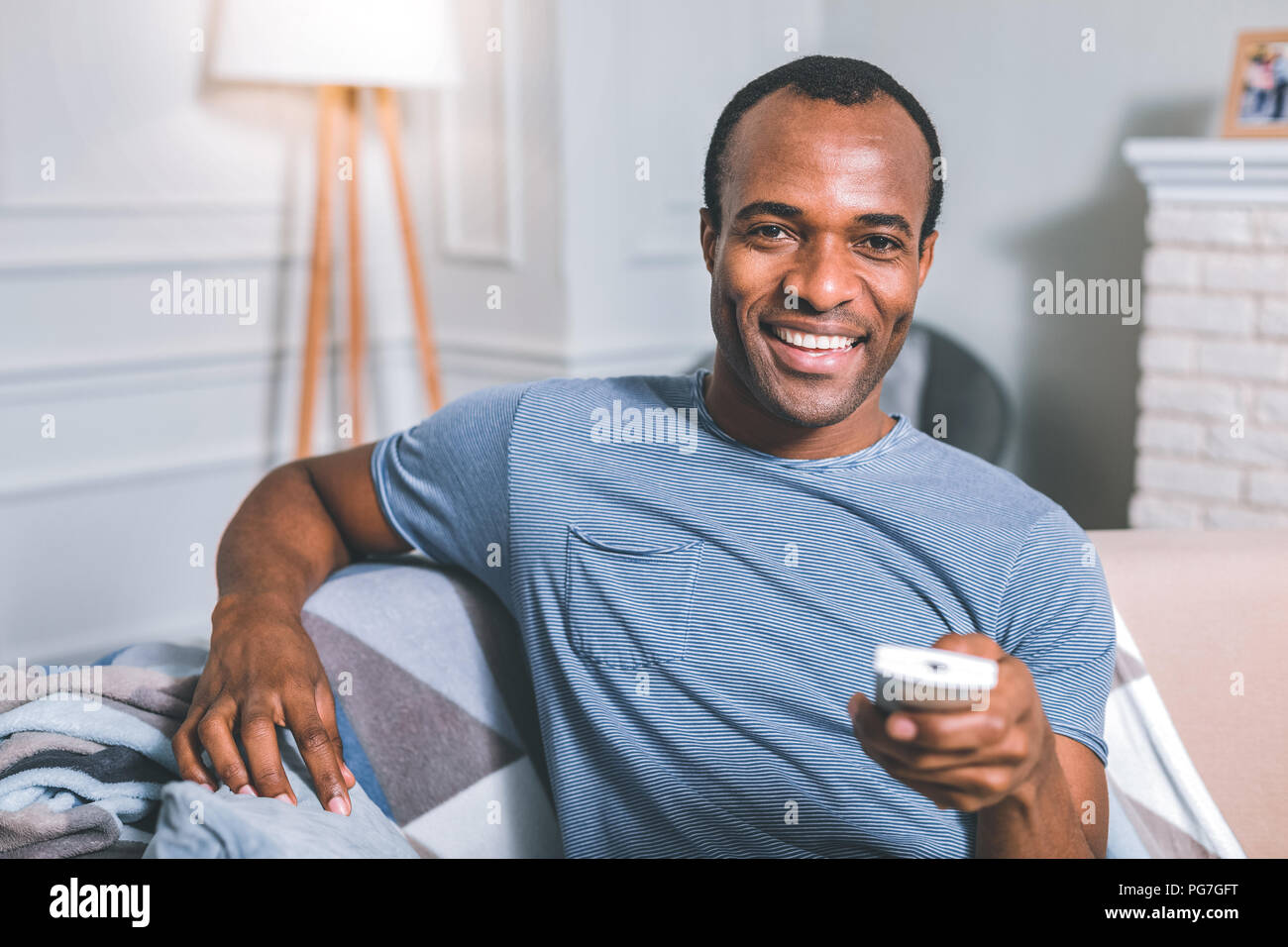 Smiling man watching television Stock Photo - Alamy