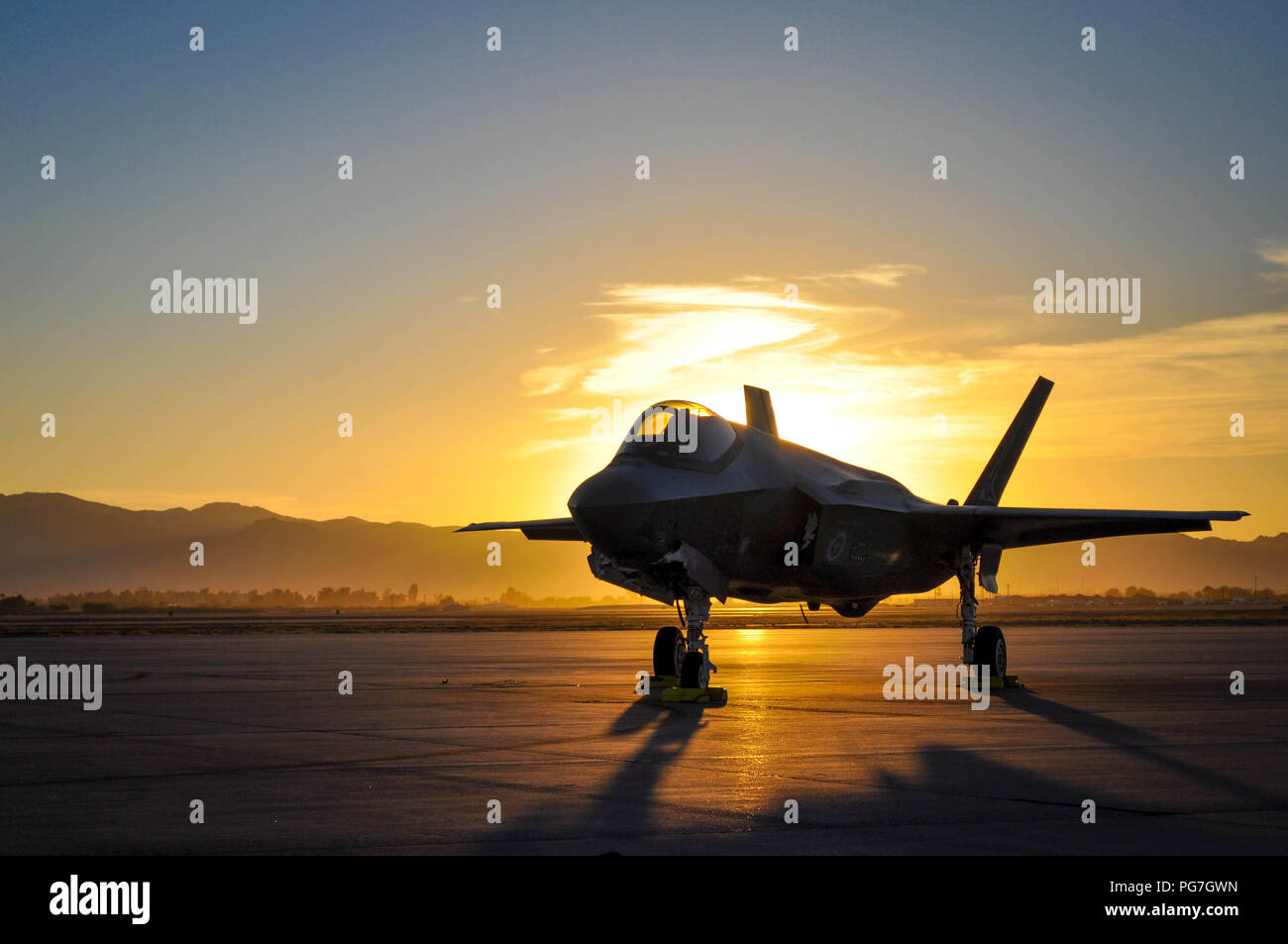 The sun sets behind an Australian F-35A Lighting II aircraft at Luke ...