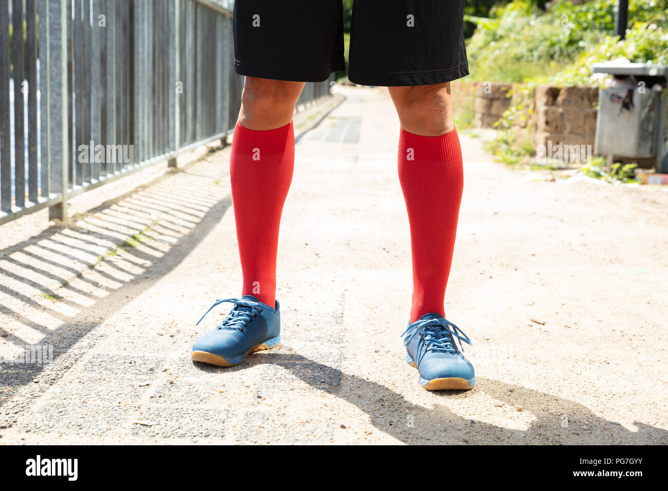 Low Section View Of A Male Runner Standing On Street Stock Photo - Alamy