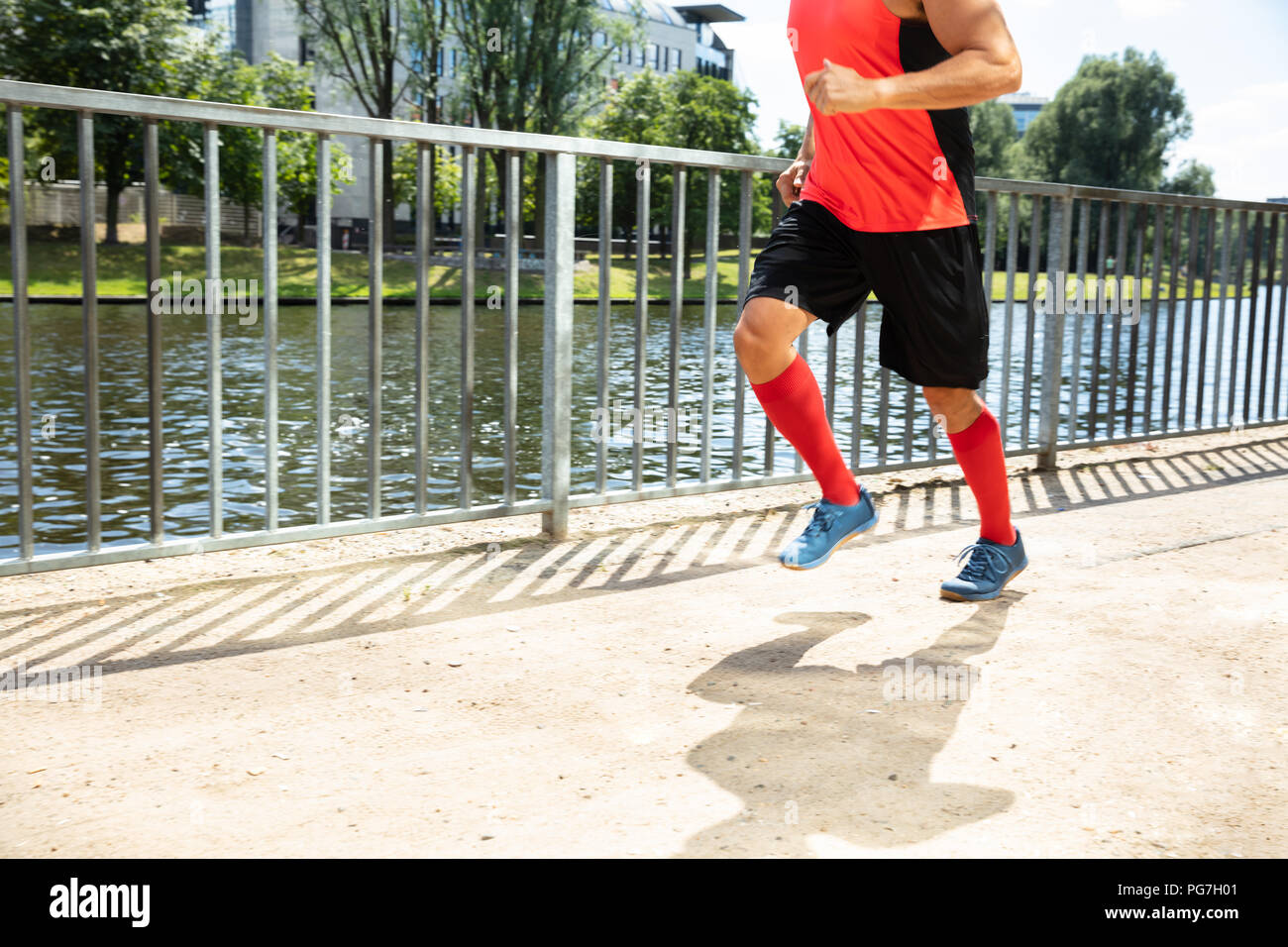 Low Section View Of A Man Running On Sidewalk At Morning Stock Photo ...