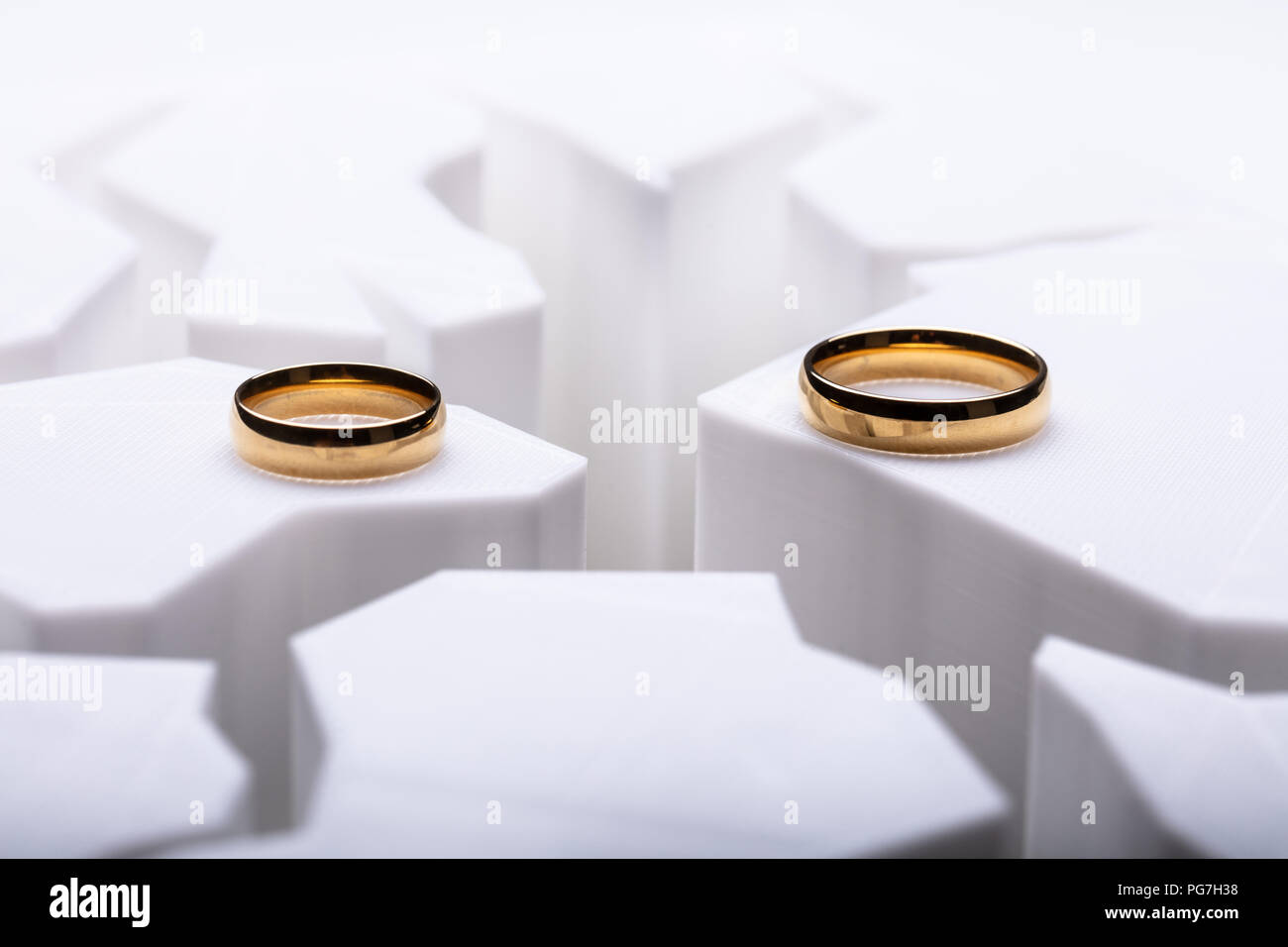 Two Separated Wedding Rings On Cracked Surface Stock Photo - Alamy