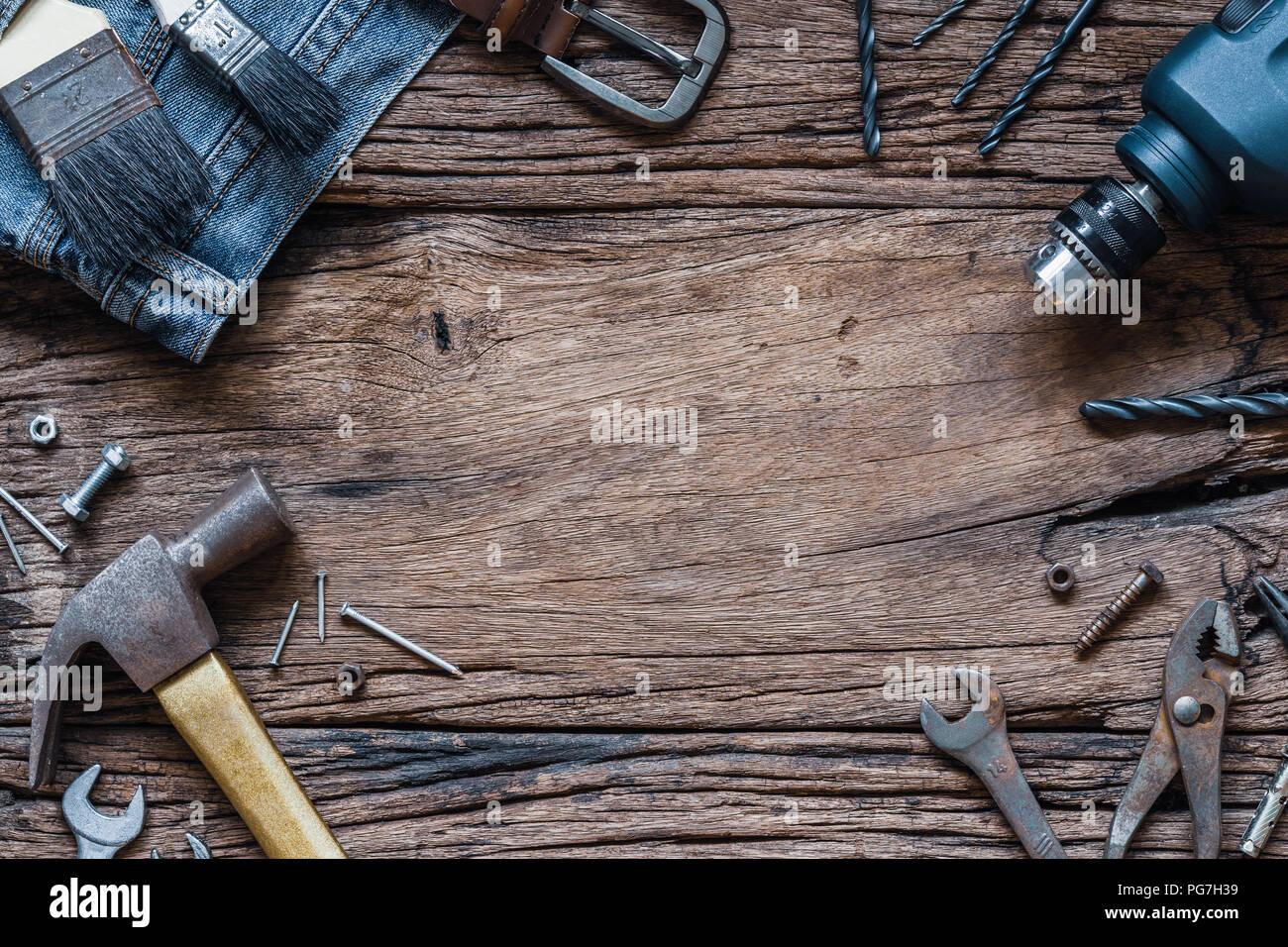 Top view close up of variety handy tools and jeans on wood background ...