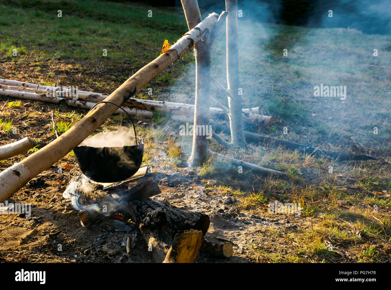 making food in cauldron on fire. steam and smoke all over the place ...
