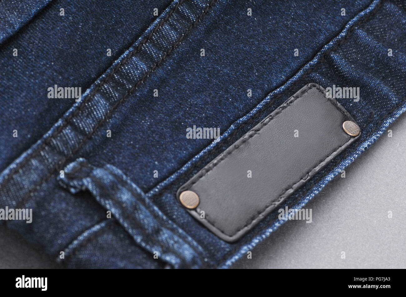 part of denim pants with back pockets and label, close-up Stock Photo ...