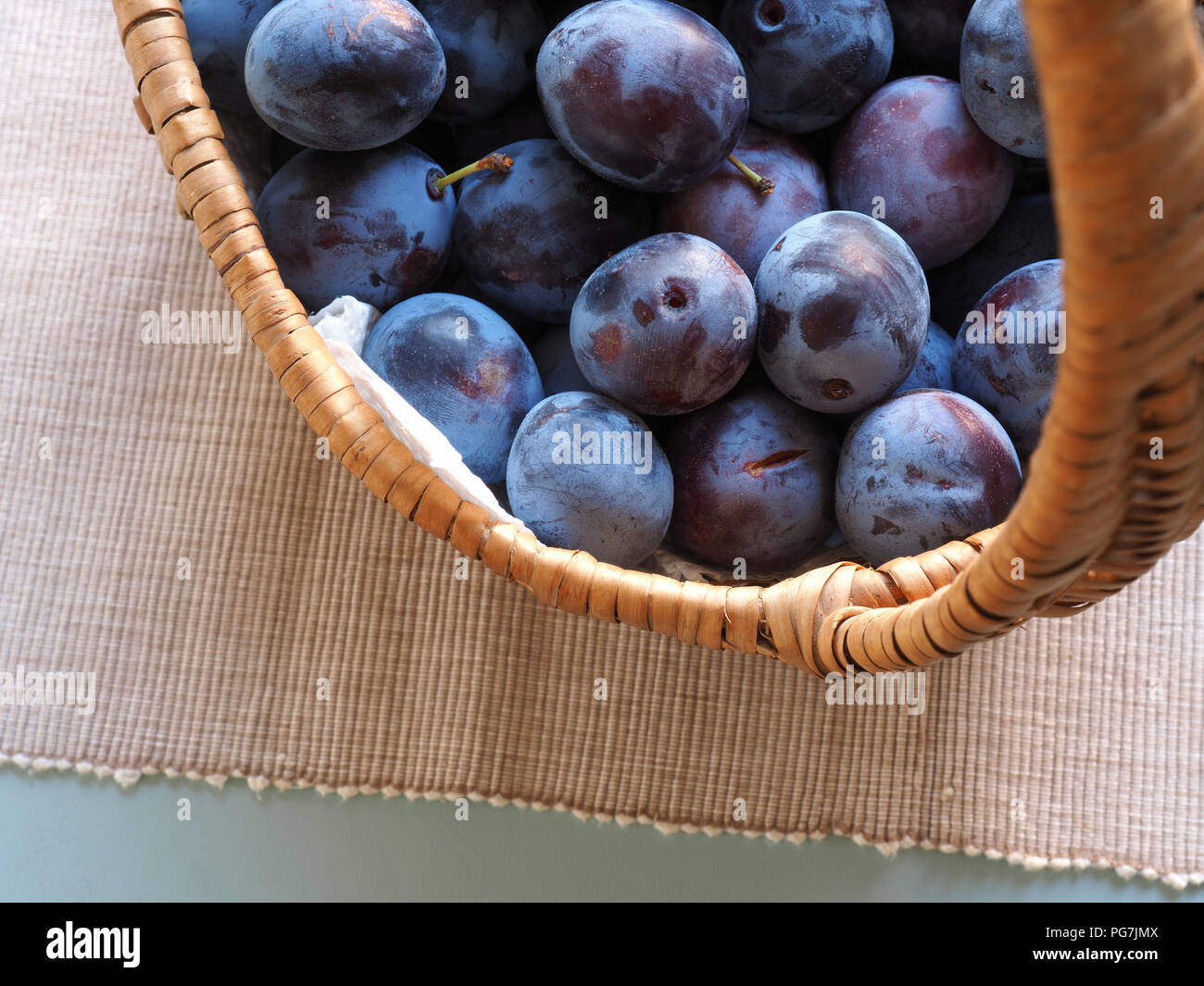 Harvested fresh organic plums in a basket, healthy food or self supply ...