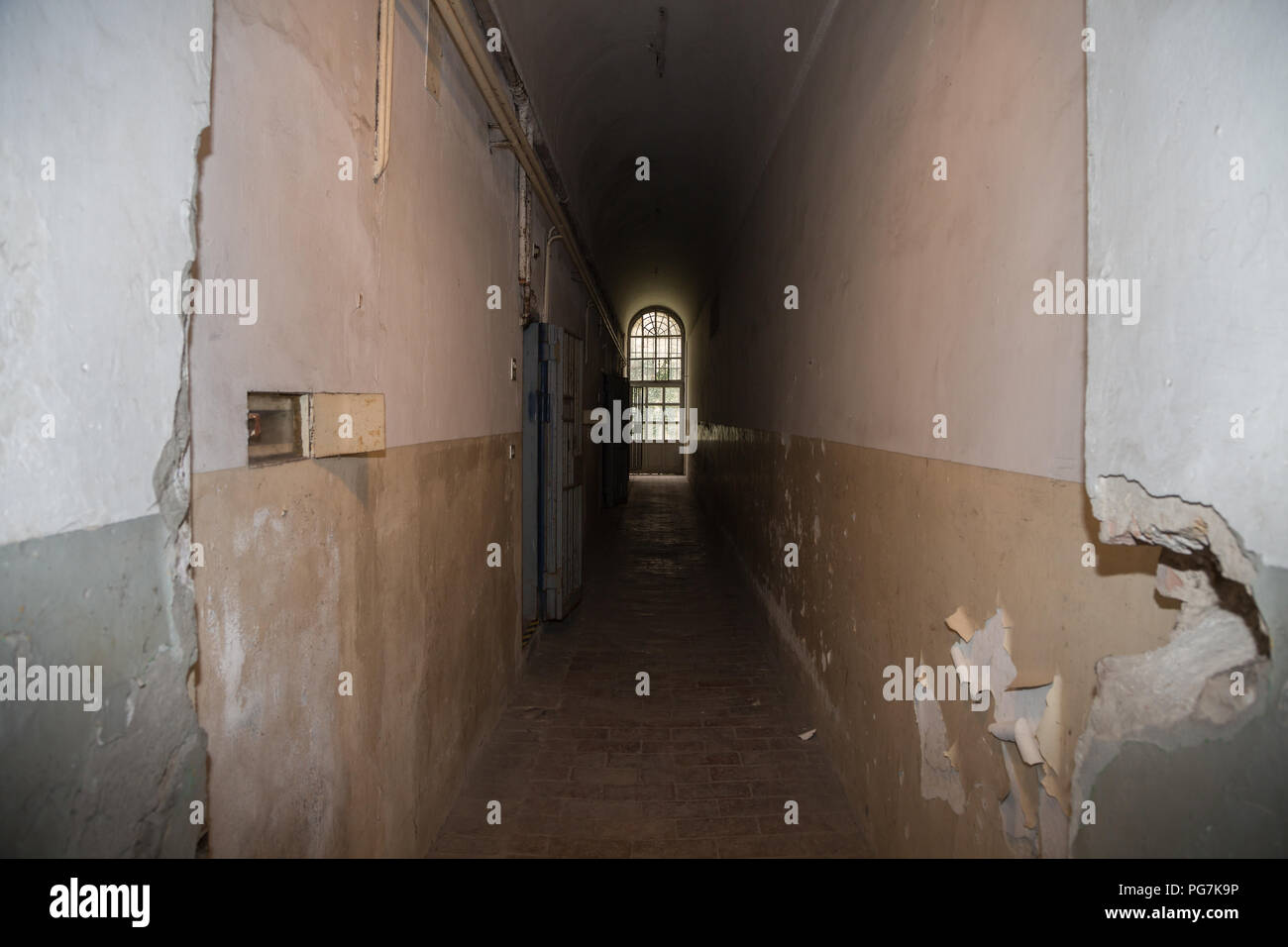 Long Corridor and White and Worn Walls of a Prison Stock Photo - Alamy