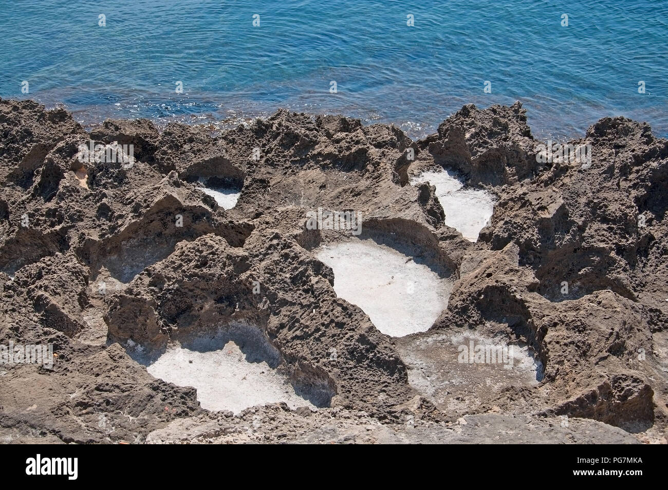 Beautiful natural coast landscape with salt cavities in rocks and ...
