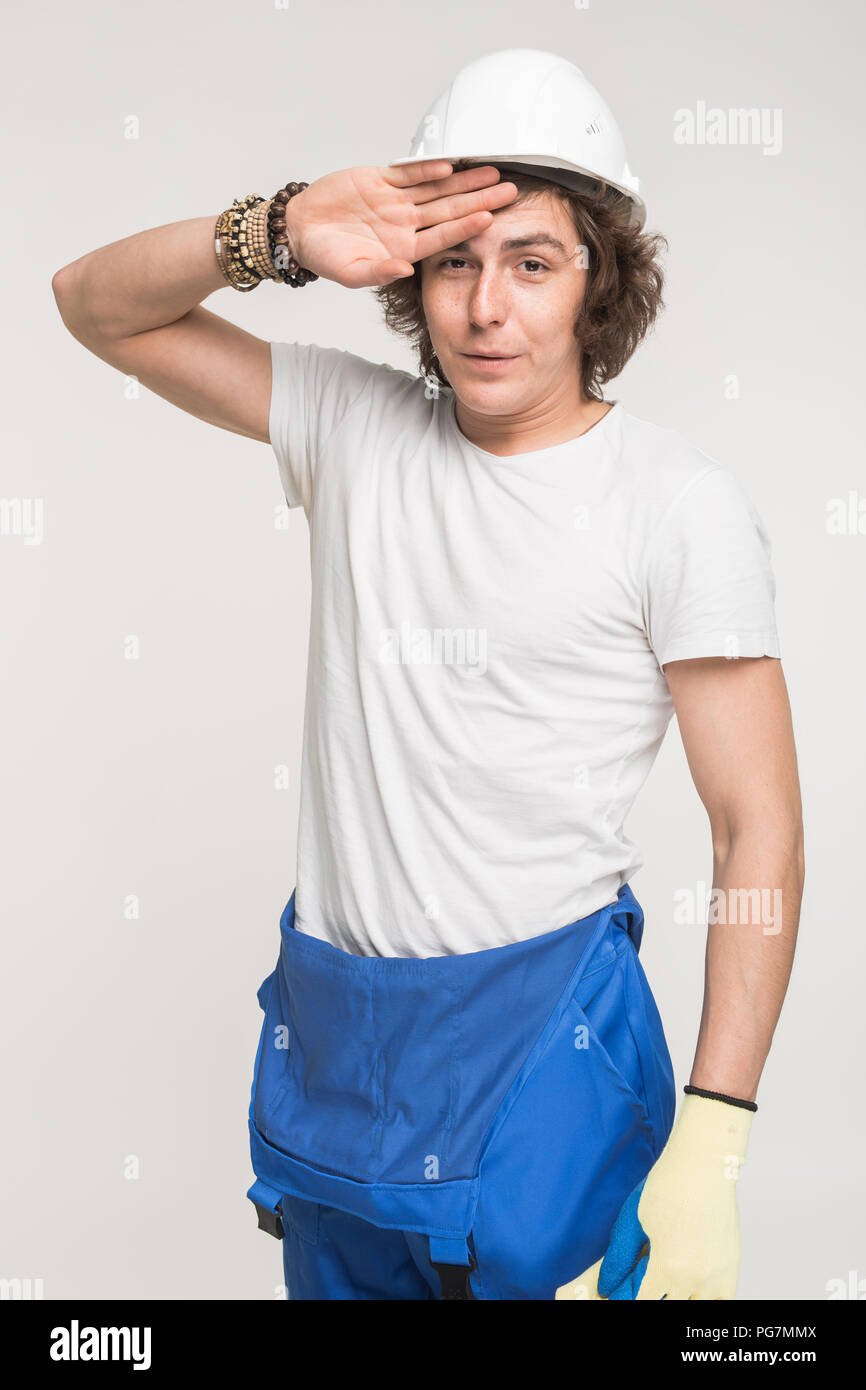 Builder man with tired face wipes forehead. Hard work concept ...