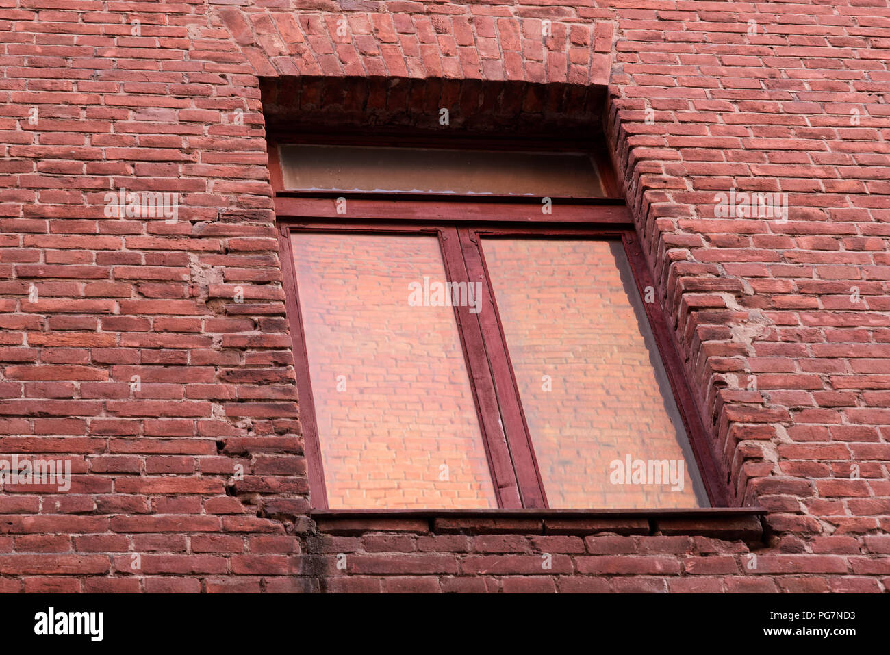Brick wall reflecting in a window in a brick wall Stock Photo - Alamy