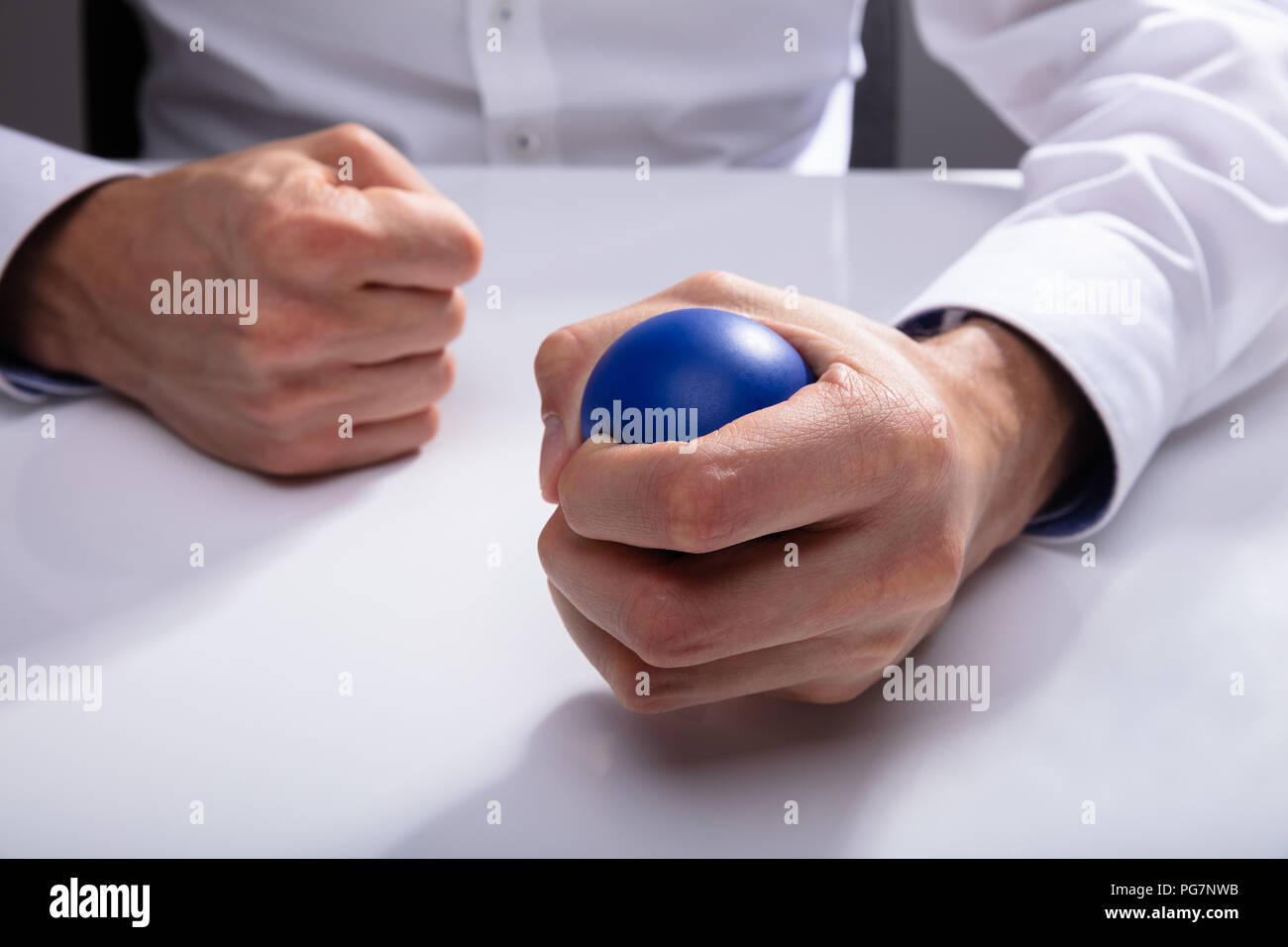 Man pressing stressball hi-res stock photography and images - Alamy