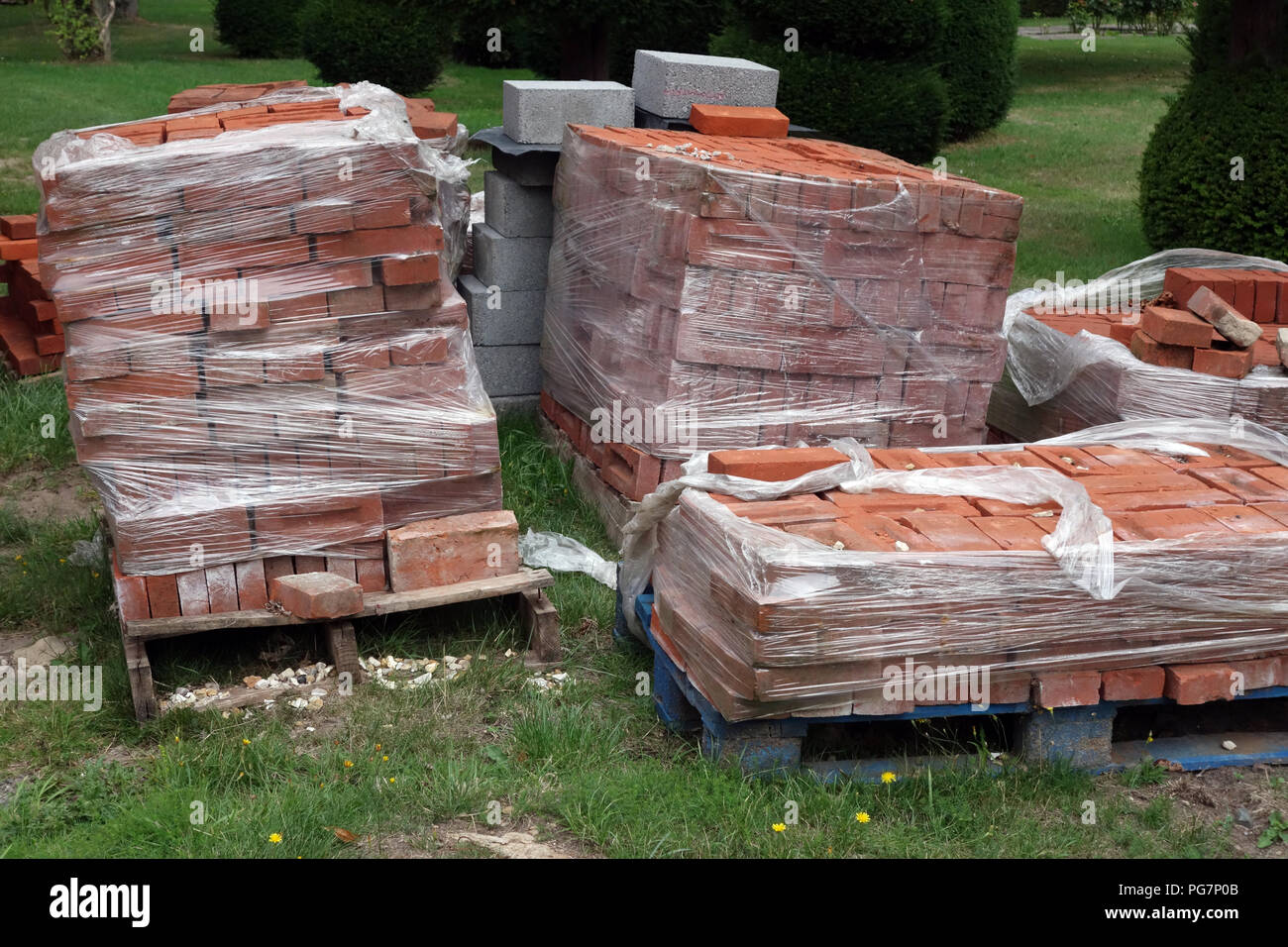 new reclaimed hand made red bricks on site Stock Photo - Alamy
