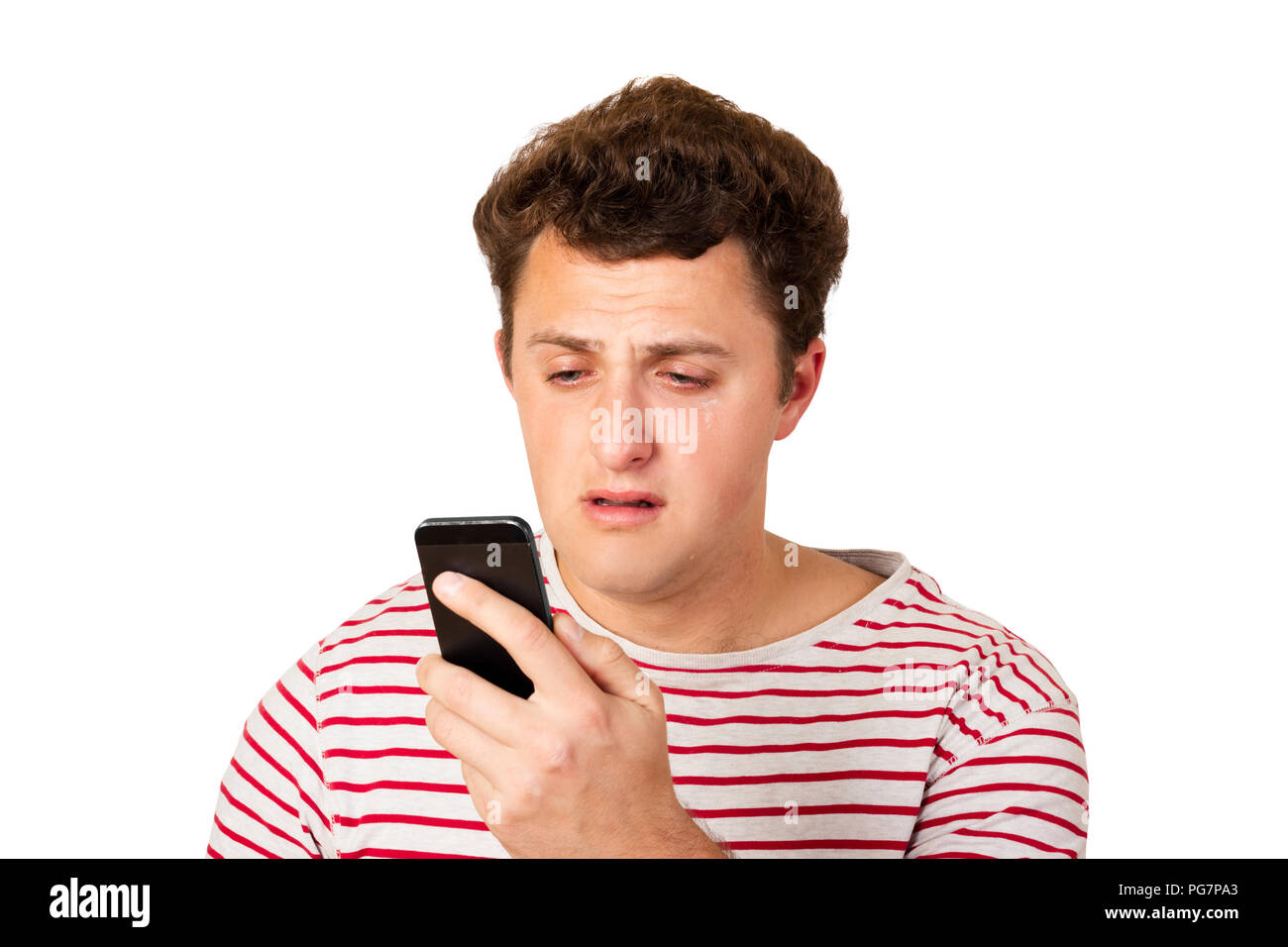 A crying man reads a text message on his phone. Sms with bad news ...