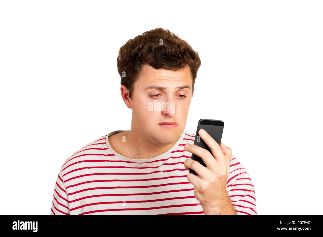 Emotional portrait of a crying man looking at his mobile phone. feeling ...
