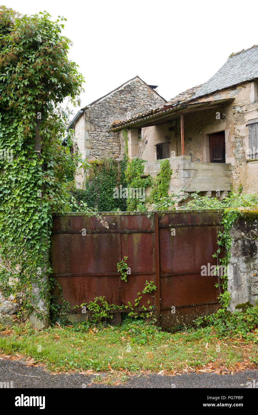 Rusty gates to an abandoned cottage in St Martial, part of the commune ...