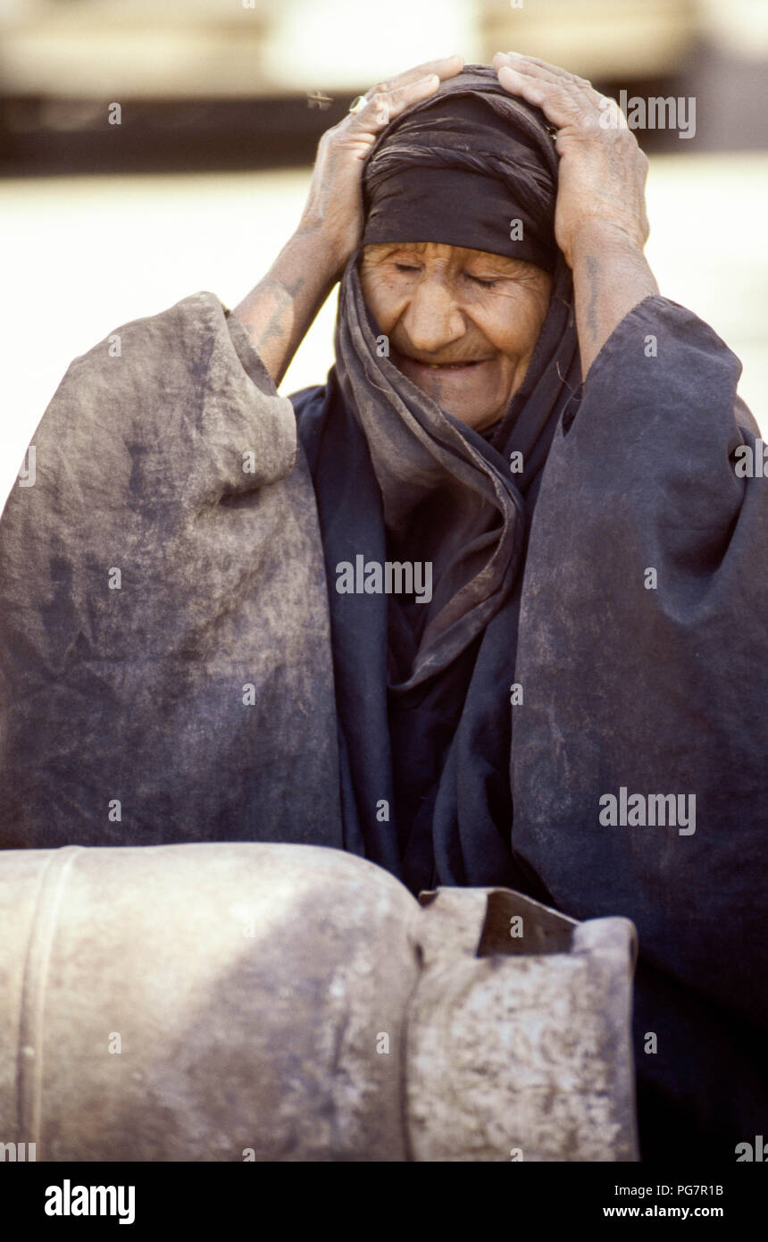 Baghdad, Iraq - October 1995 - An elderly Iraqi woman rolls a butane ...