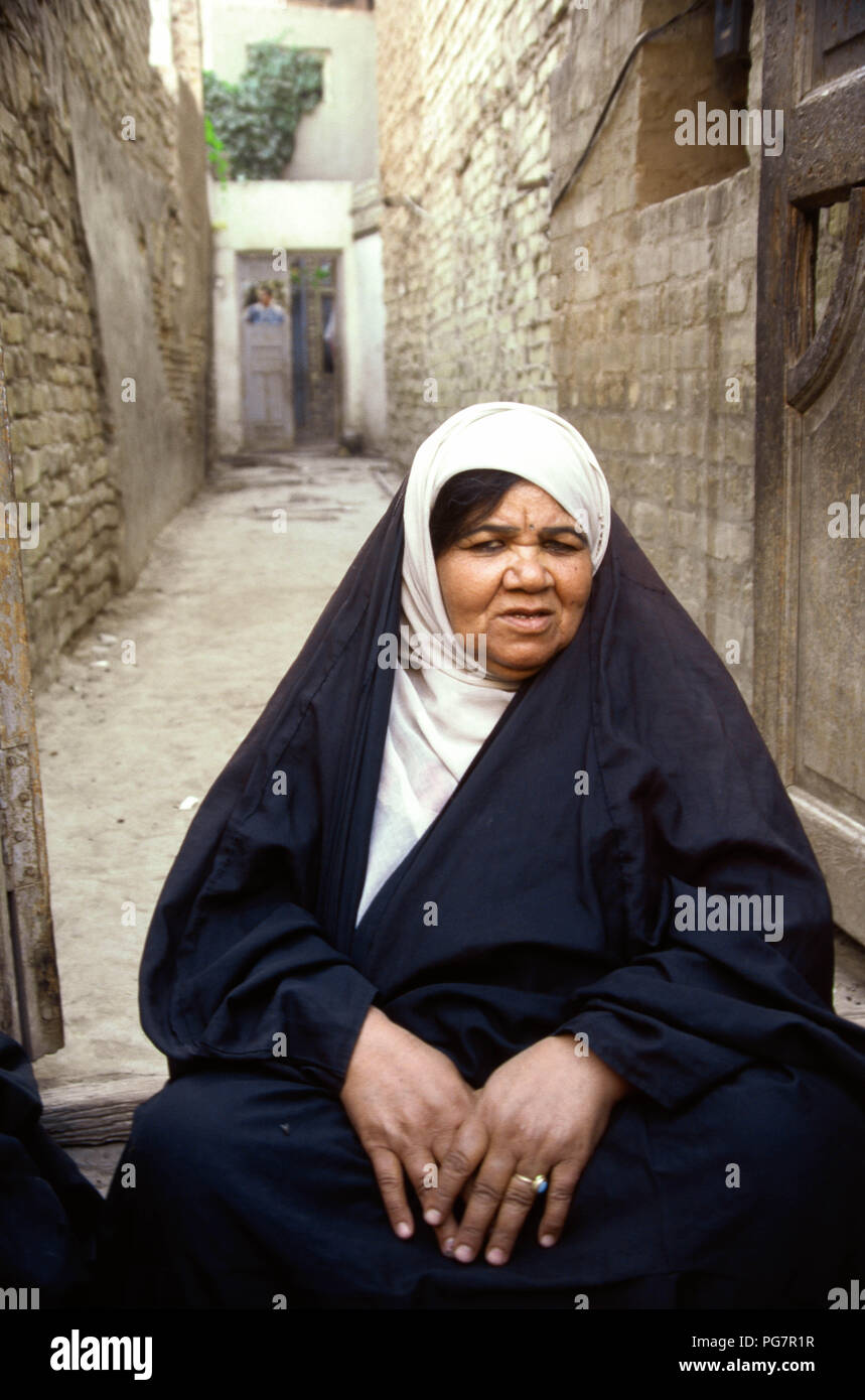 Baghdad, Iraq - October 1995 - A woman sits in an alleyway in Kharq ...