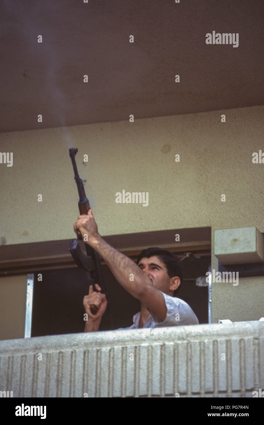 Joyous Iraqi firing gun from his apartment block balcony, in ...