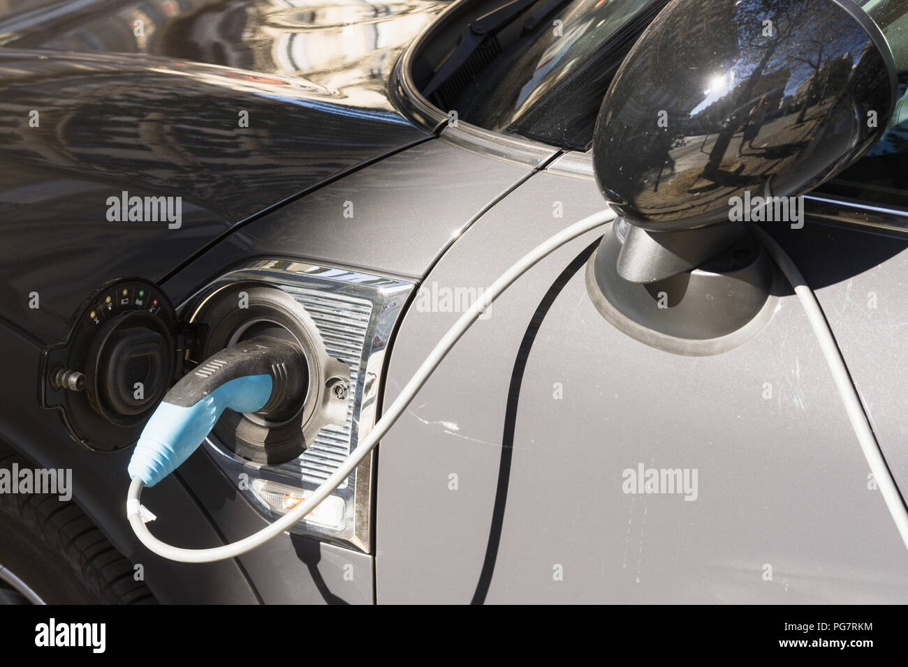 Electrci car charging - Close up of a power socket on grey electric car ...