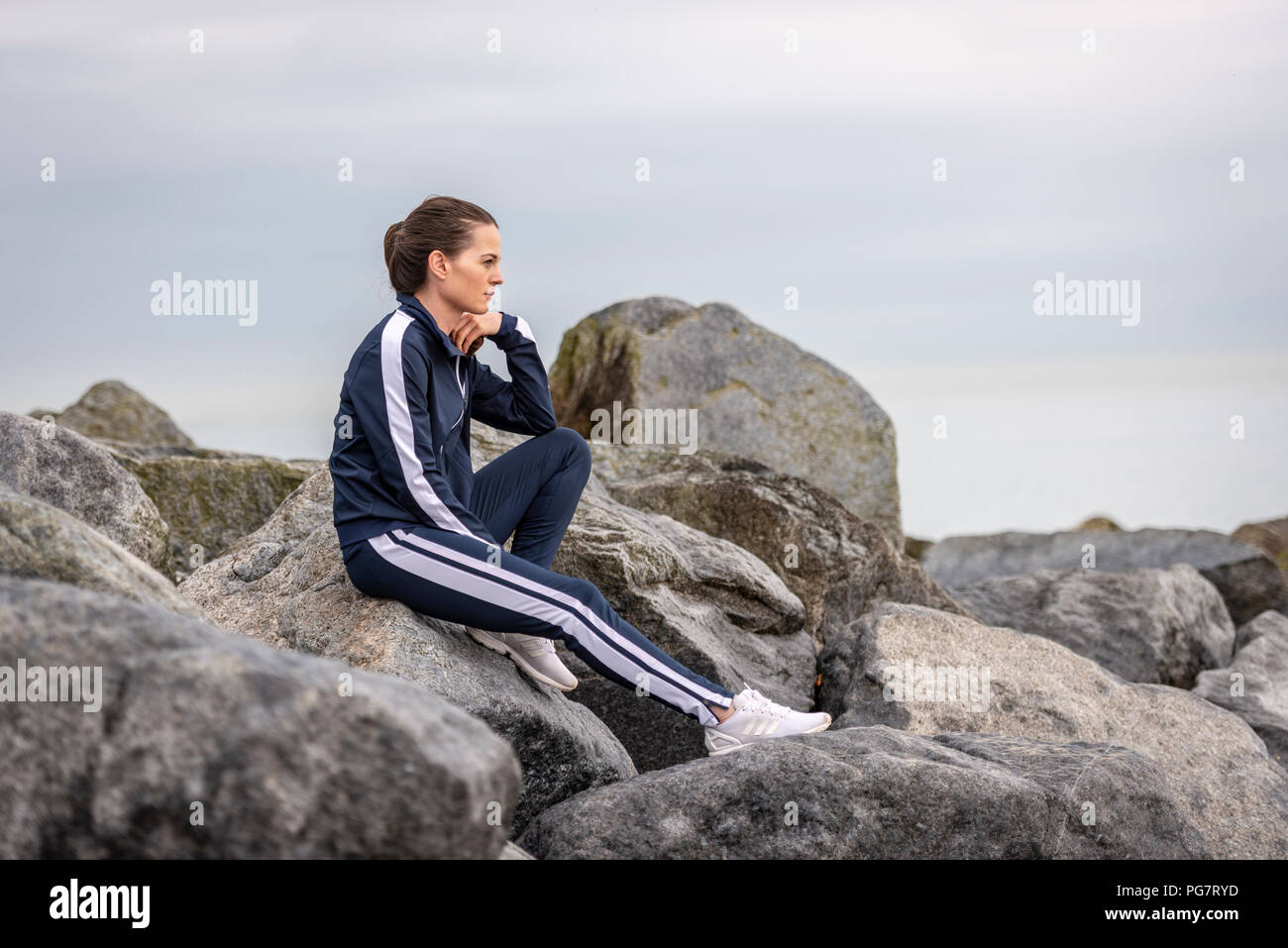 Woman resting on rocks hi-res stock photography and images - Alamy