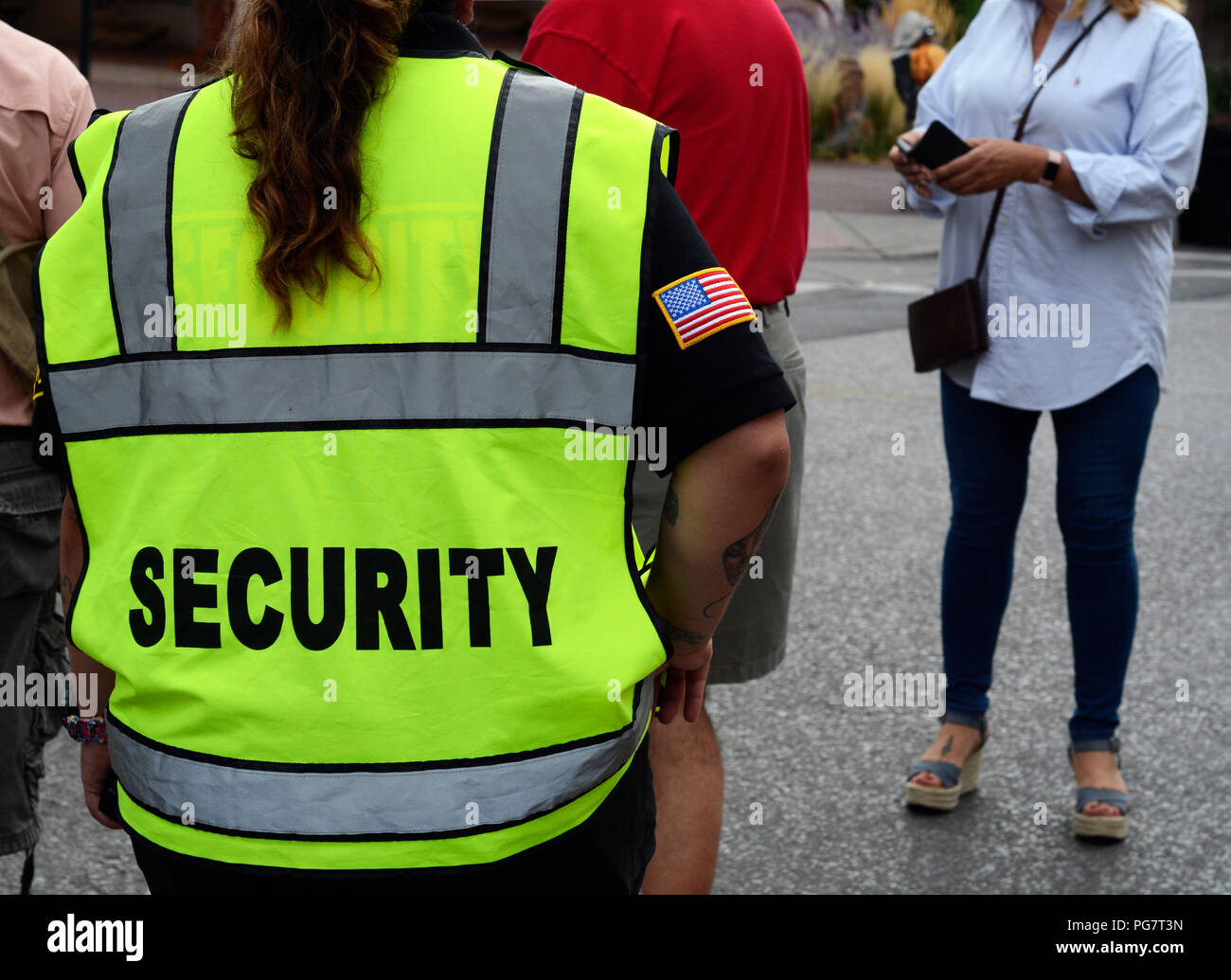 A police officer wears a security vest at an outdoor art show Stock ...
