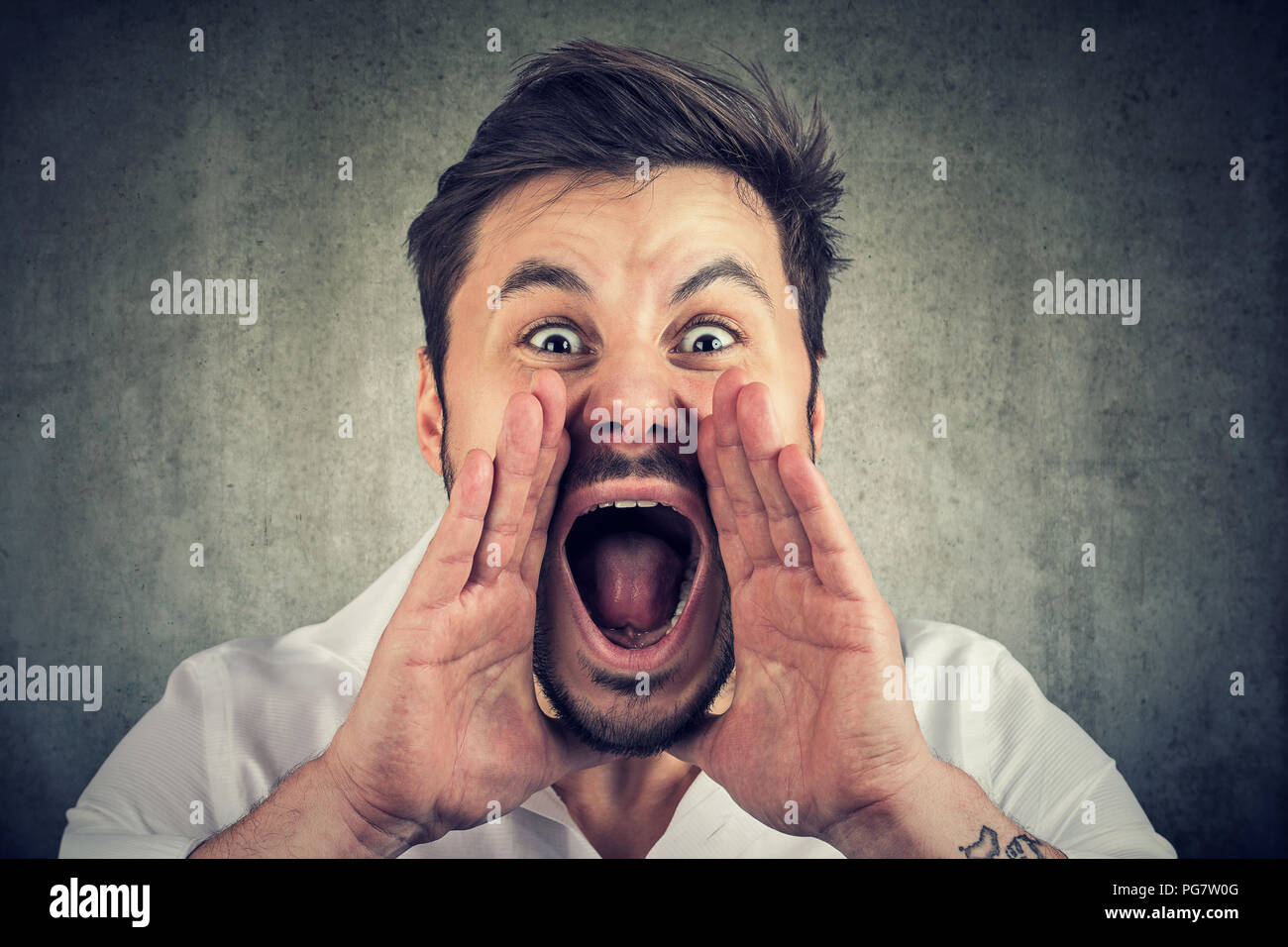 Closeup portrait of upset, angry man with hands close to wide opened ...