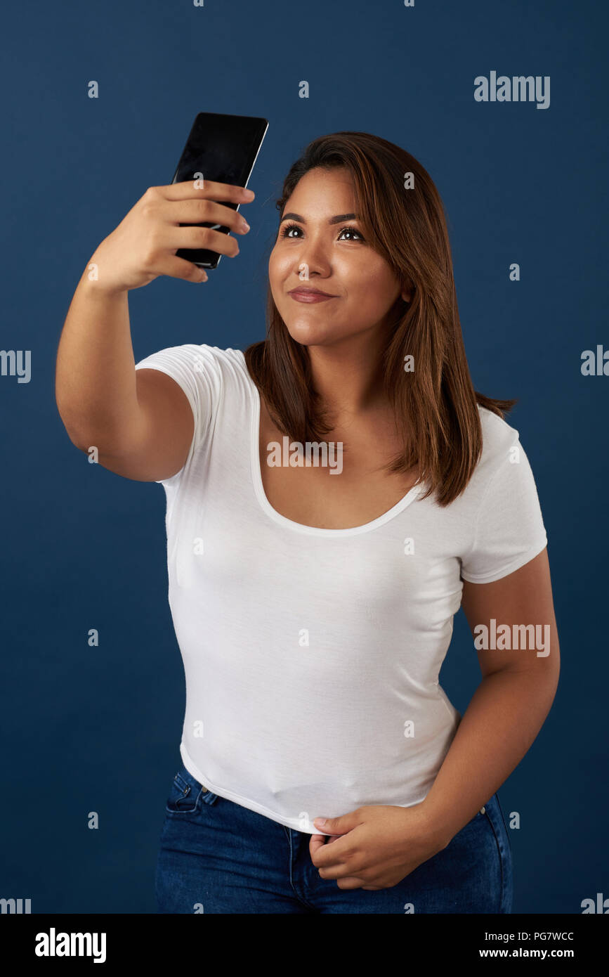 Making selfie theme. Hispanic woman take self portrait Stock Photo - Alamy