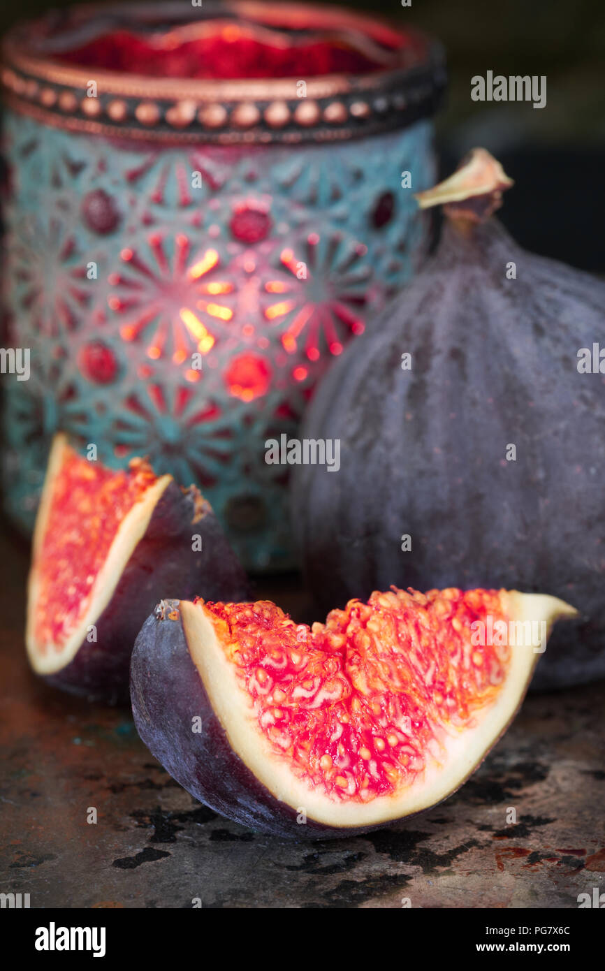 Close-up on a sliced quarter of fresh black fig on a vintage metal ...