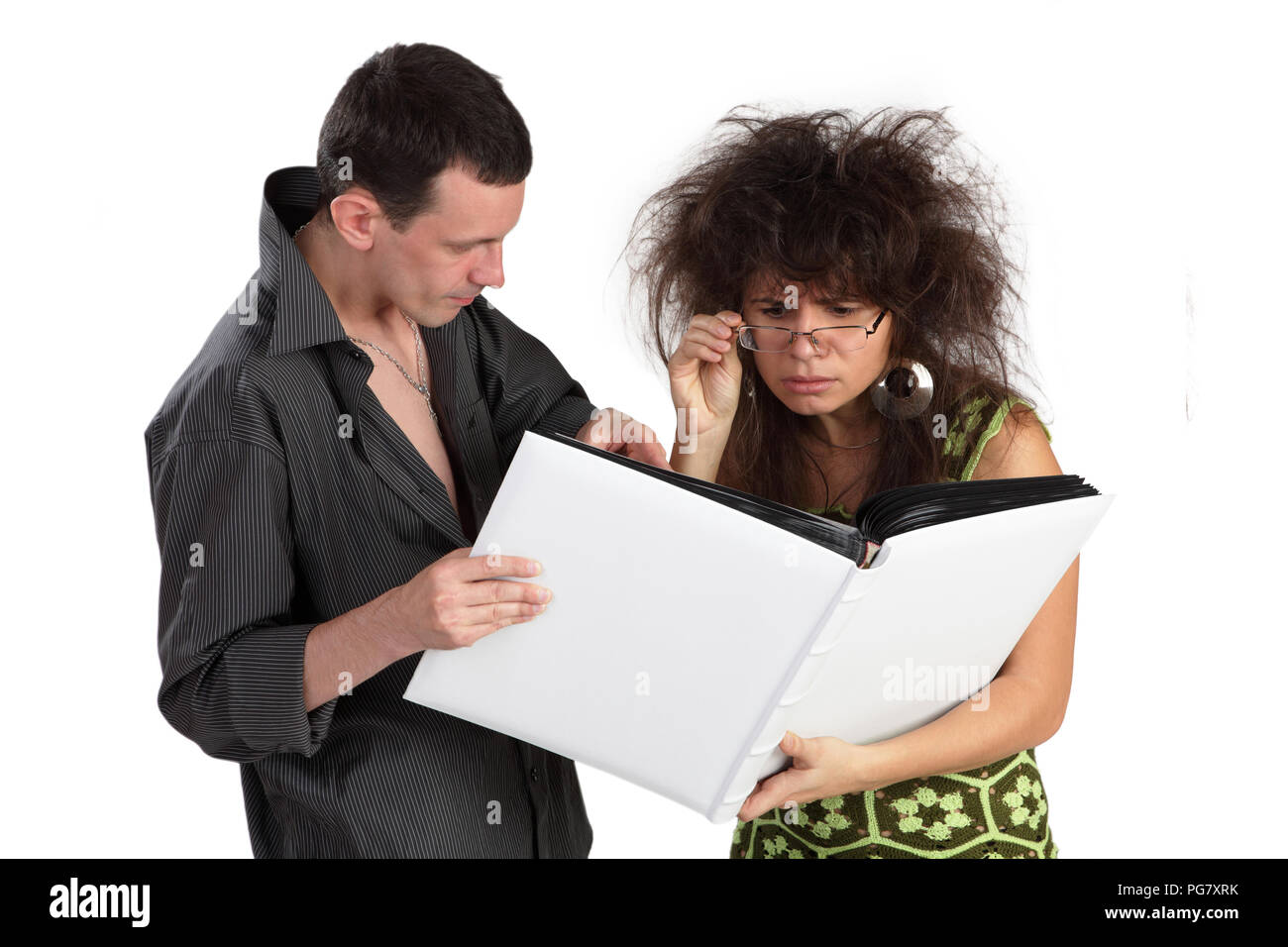 The guy and the girl look the book or photo album isolated on a white ...