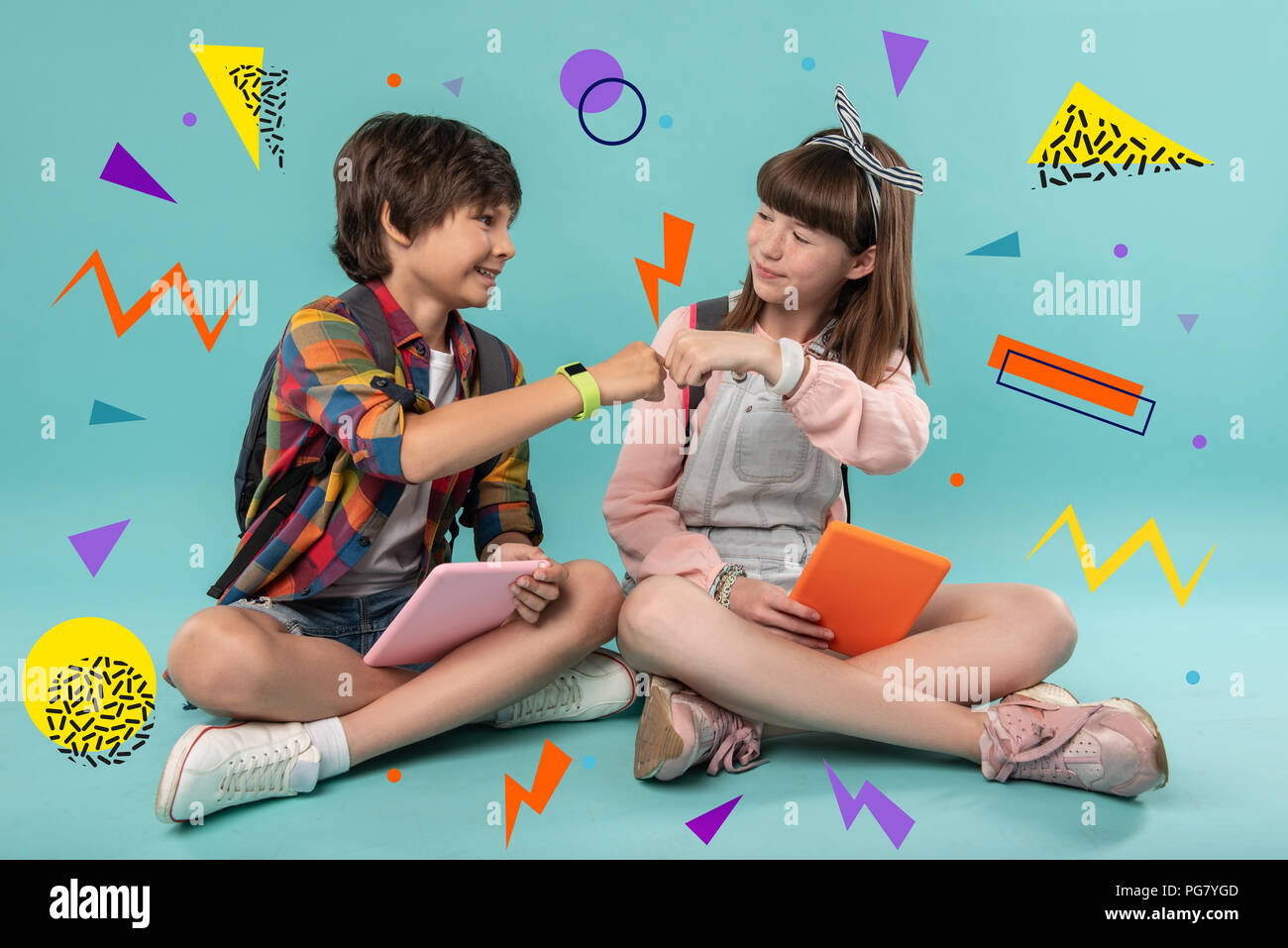 Emotional kids having fun and putting their fists together Stock Photo ...