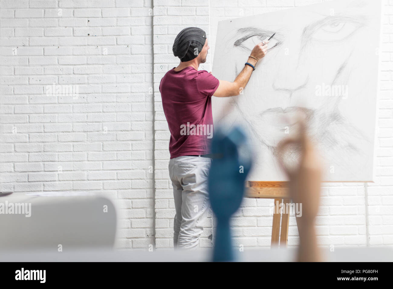 Artist drawing in studio Stock Photo - Alamy