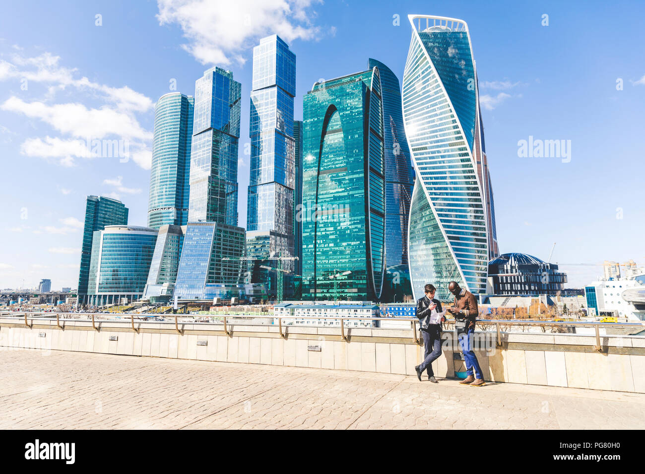 Russia, Moscow, two businessmen standing in front of modern office ...