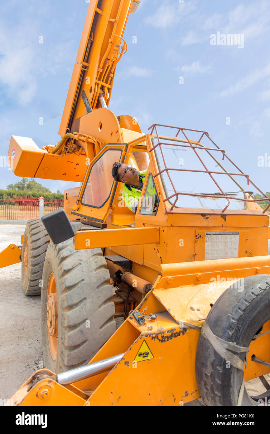 Construction worker operating crane Stock Photo - Alamy
