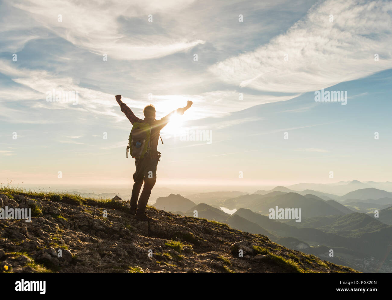 Austria, Salzkammergut, Hiker reaching summit, raising arms, cheering ...