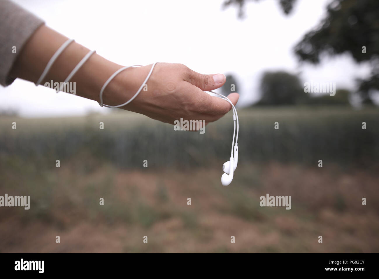 Woman's hand holding earphones Stock Photo - Alamy