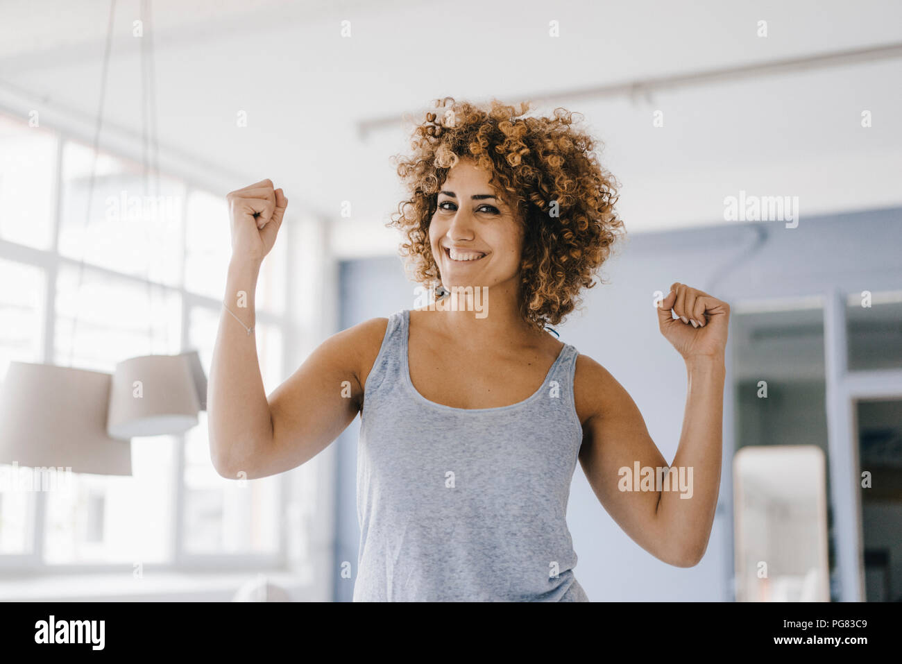 Power woman flexing muscles, portrait Stock Photo - Alamy