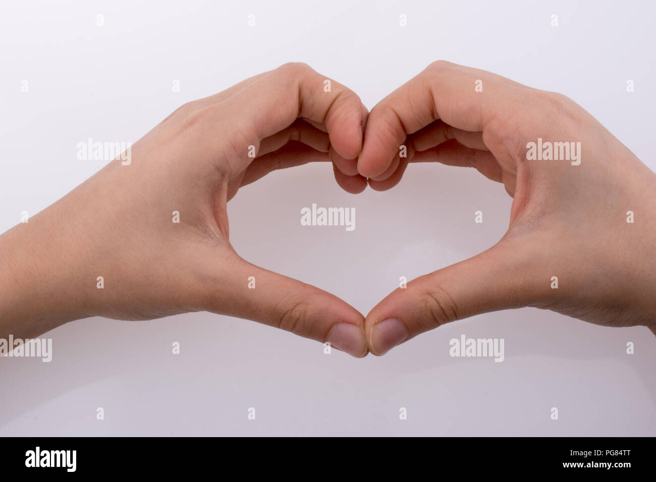 Hand making a heart shape on a white background Stock Photo - Alamy