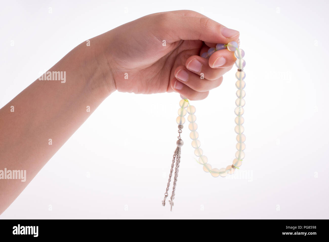 Hand holding a tespih on a white background Stock Photo - Alamy