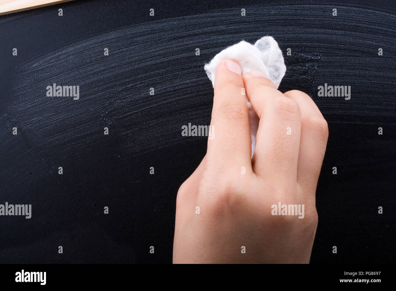 Hand cleaning blackboard on a white background Stock Photo - Alamy