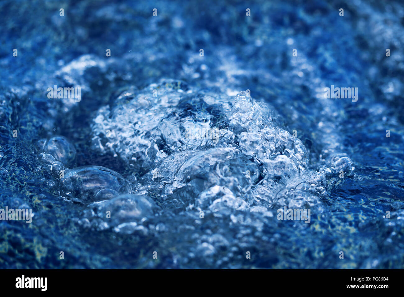 Photo background of bright bubbling blue water Stock Photo - Alamy