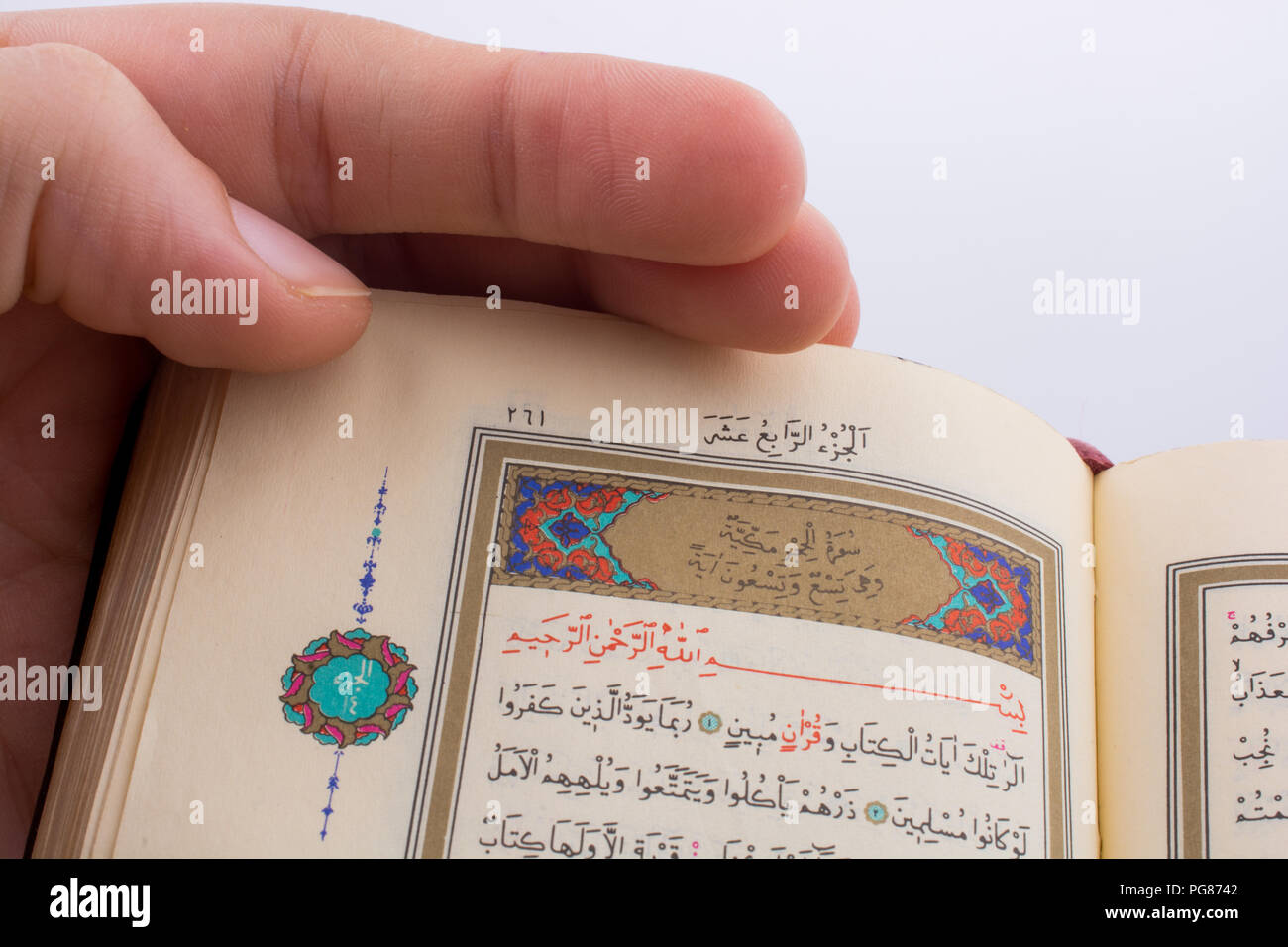 Hand holding The Holy Quran on a white background Stock Photo - Alamy