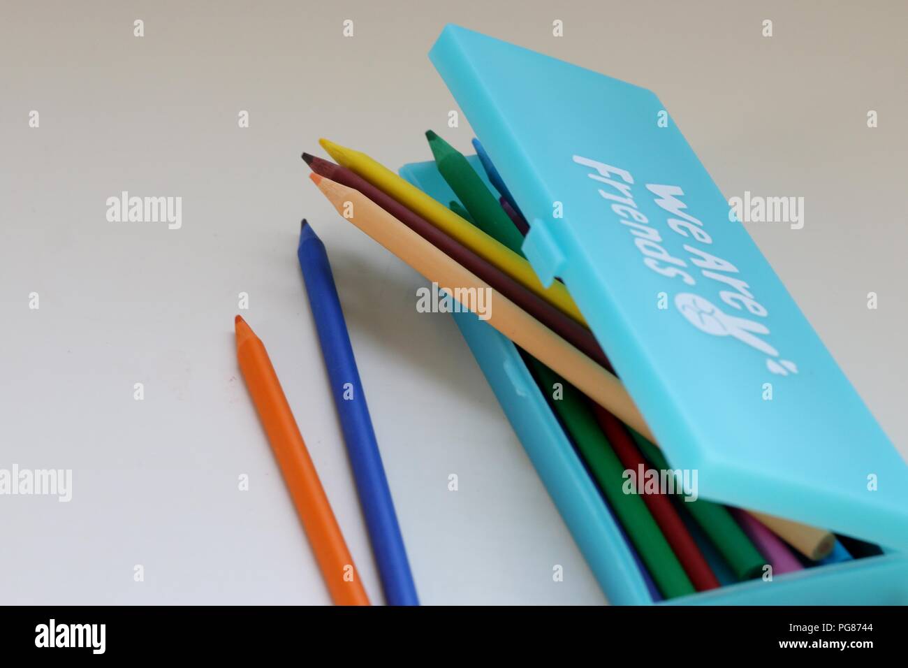 Colored pencils in a light blue pencil case Stock Photo - Alamy