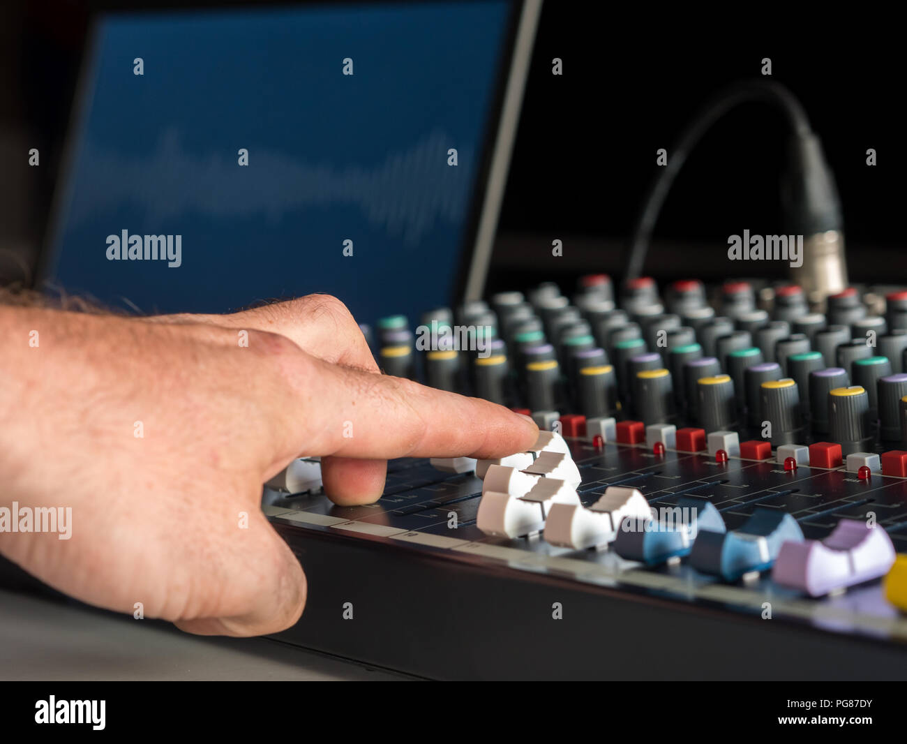 Man adjusting sound on audio mixer in radio station Stock Photo - Alamy